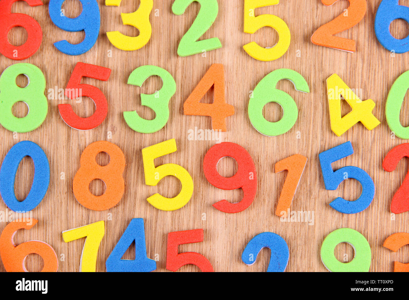 Colorful numbers on wooden background Stock Photo - Alamy