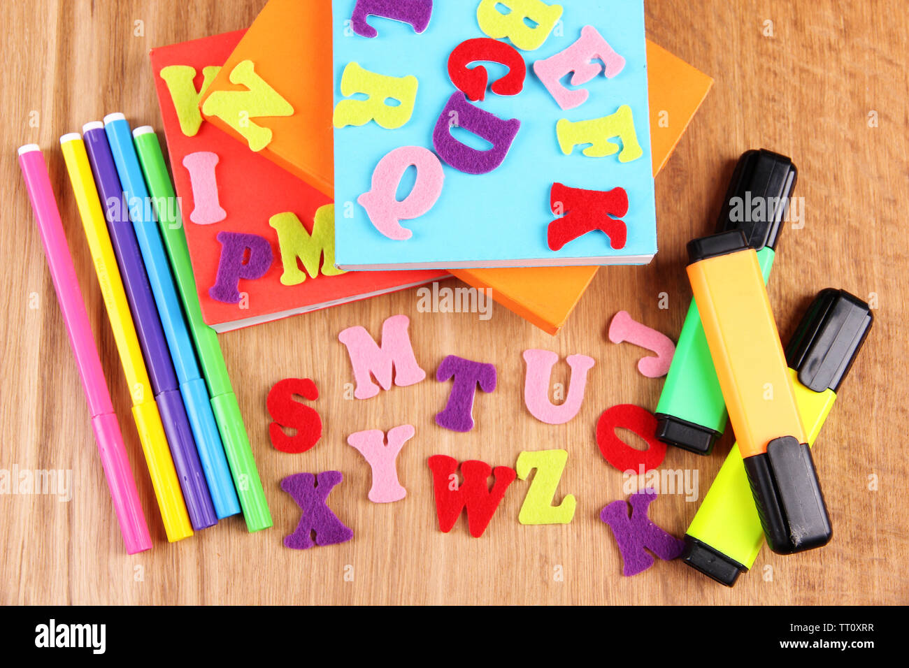 English alphabet, books and markers on wooden background Stock Photo ...