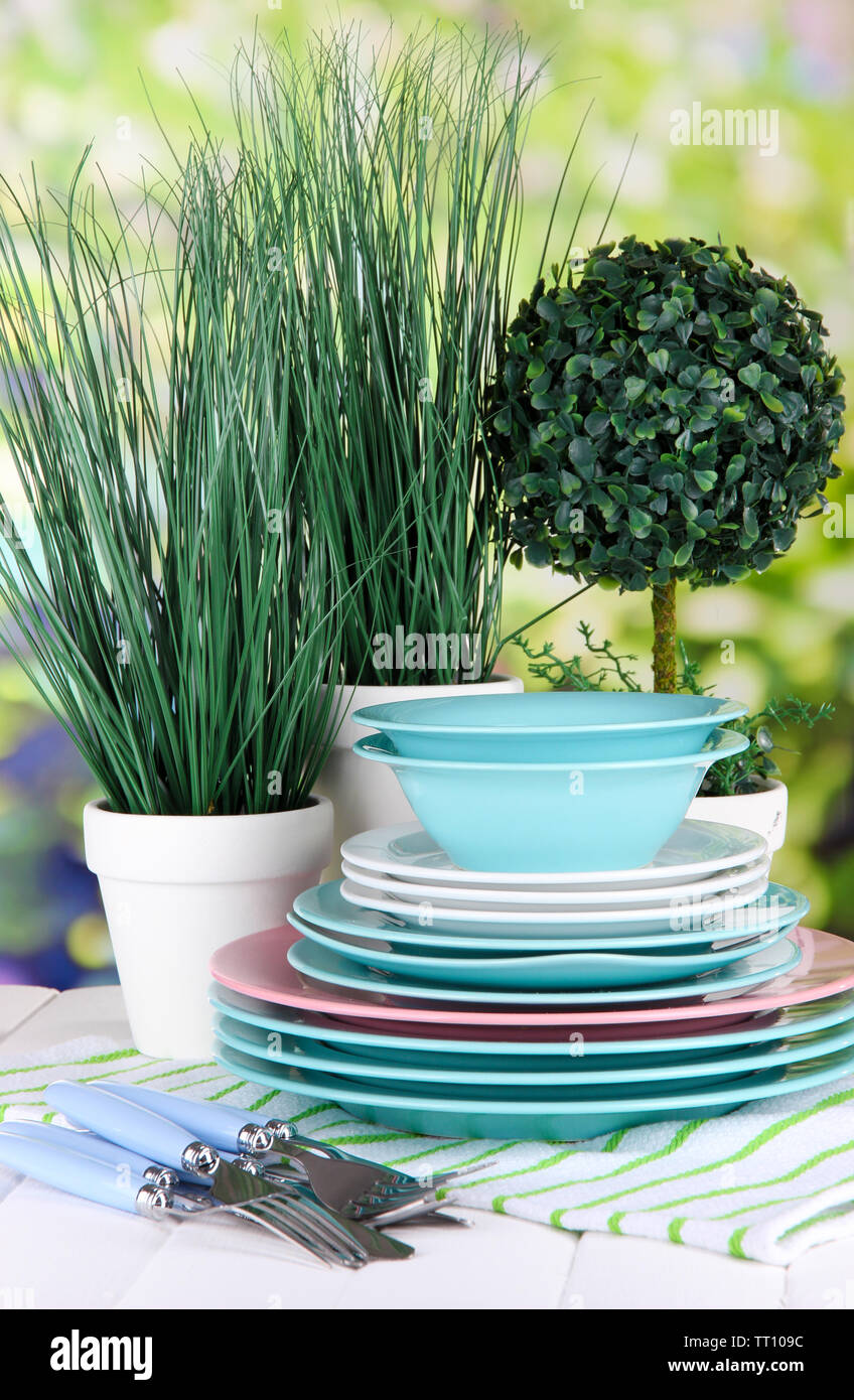 Clean dishes with flowers on wooden table on natural background Stock ...