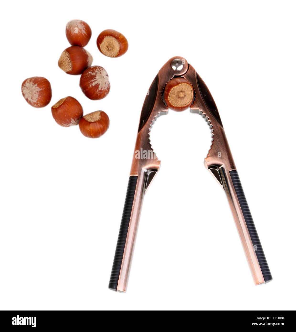 Nutcracker and hazelnuts isolated on white Stock Photo - Alamy