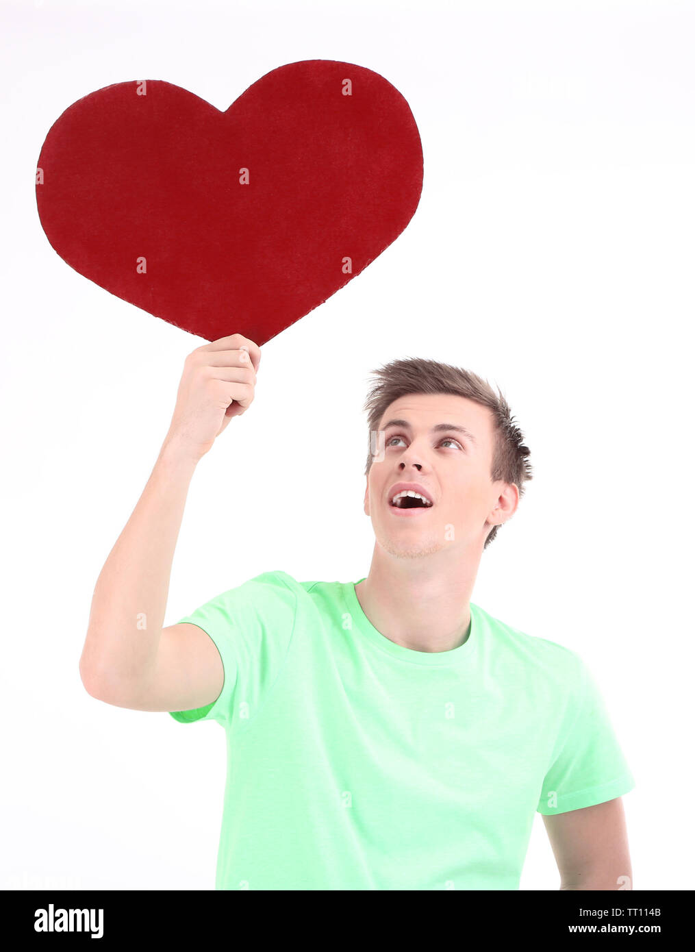 Handsome young man with big red heart, isolated on white Stock Photo ...
