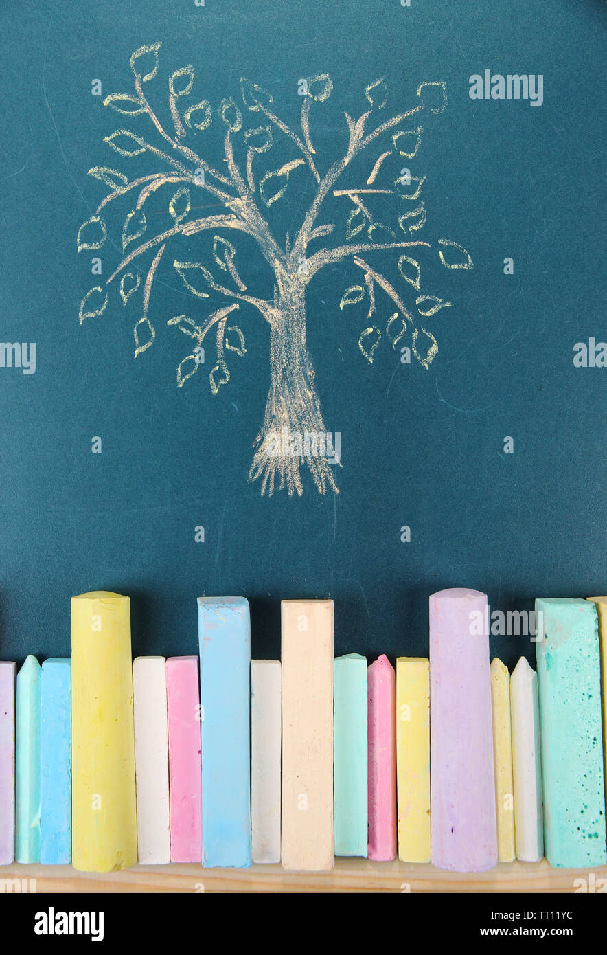 Colorful chalks and drawing on school desk Stock Photo - Alamy