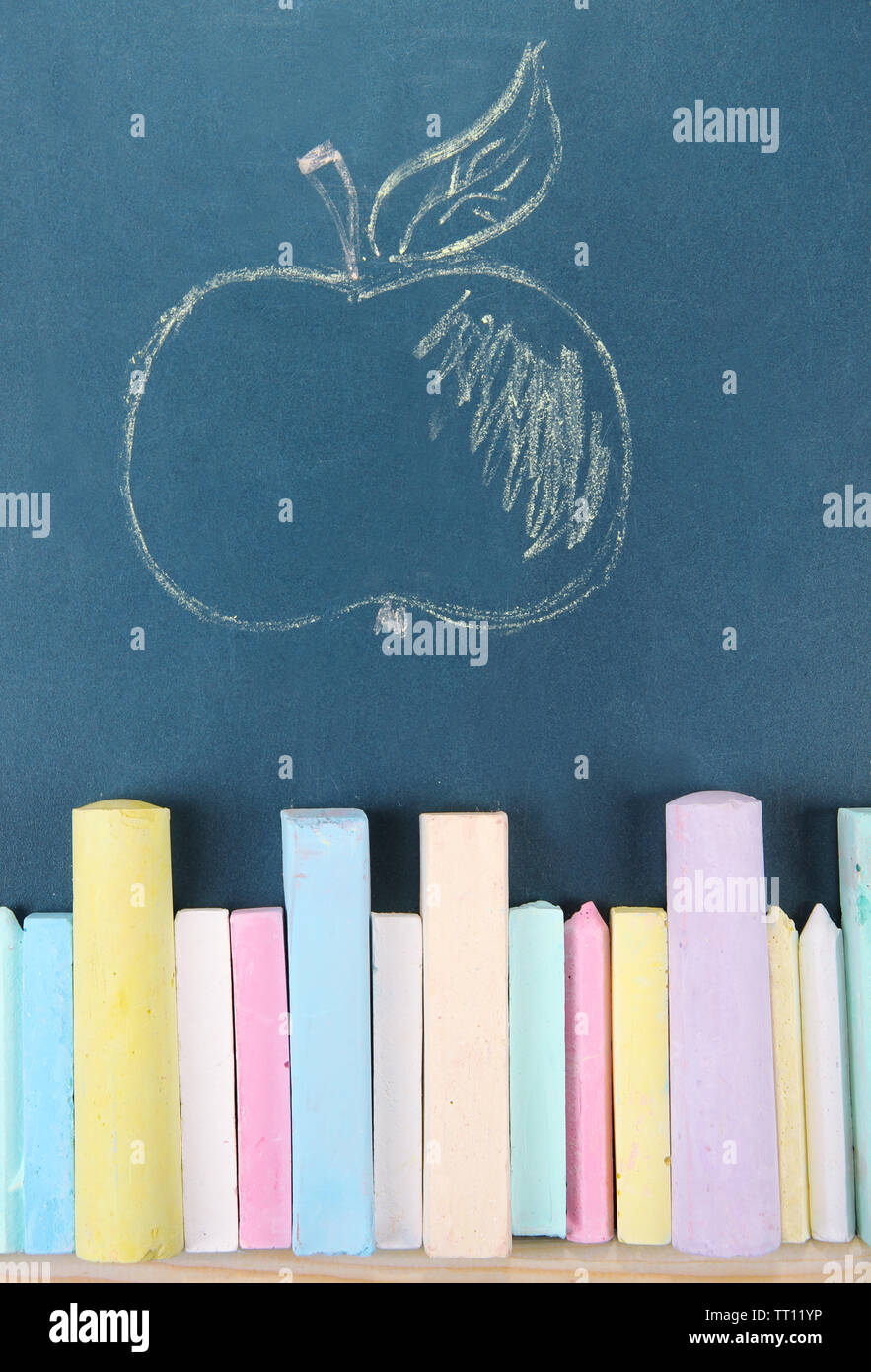 Colorful chalks and drawing on school desk Stock Photo - Alamy