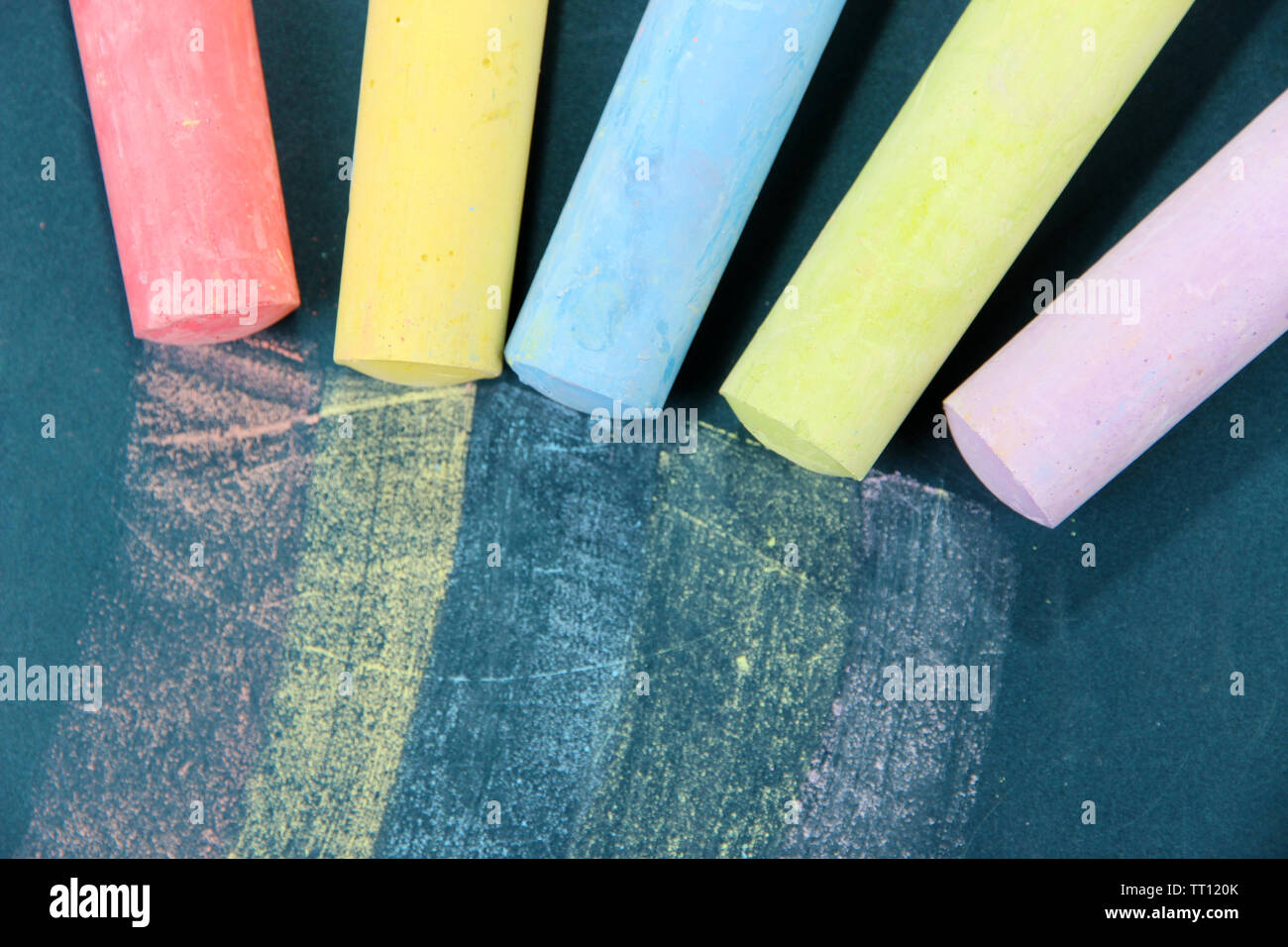 Colorful chalks on school desk Stock Photo - Alamy