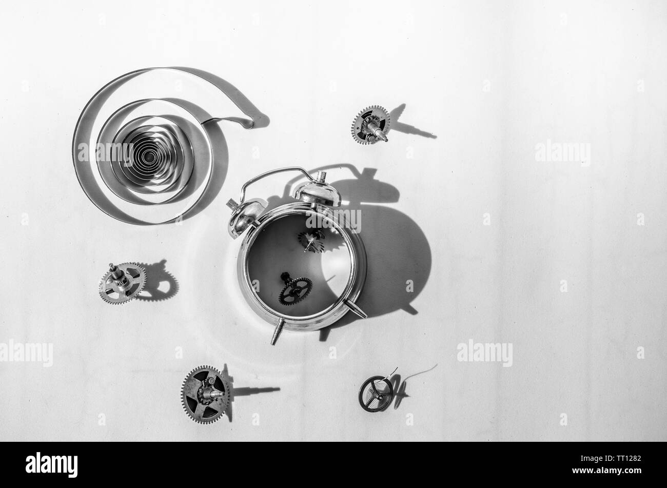 Disassembled alarm clock with scattered gears with a view from the top ...