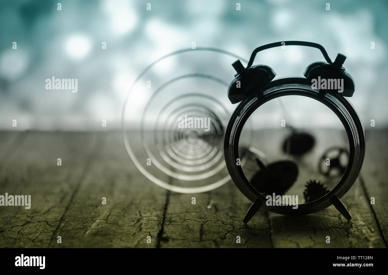 Broken alarm clock with springs and gears scattered on the background ...