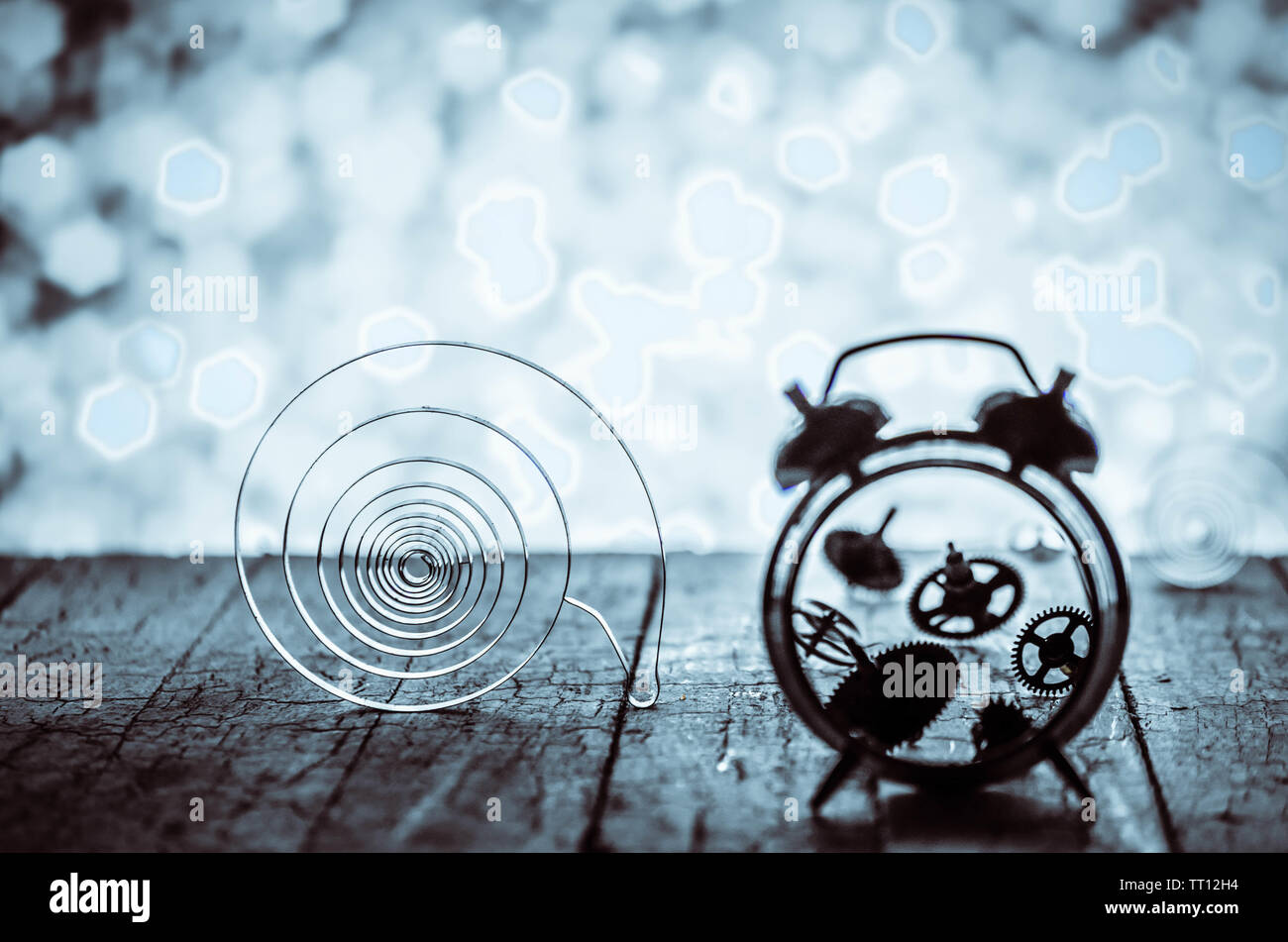 Broken alarm clock with springs and gears scattered on the background ...