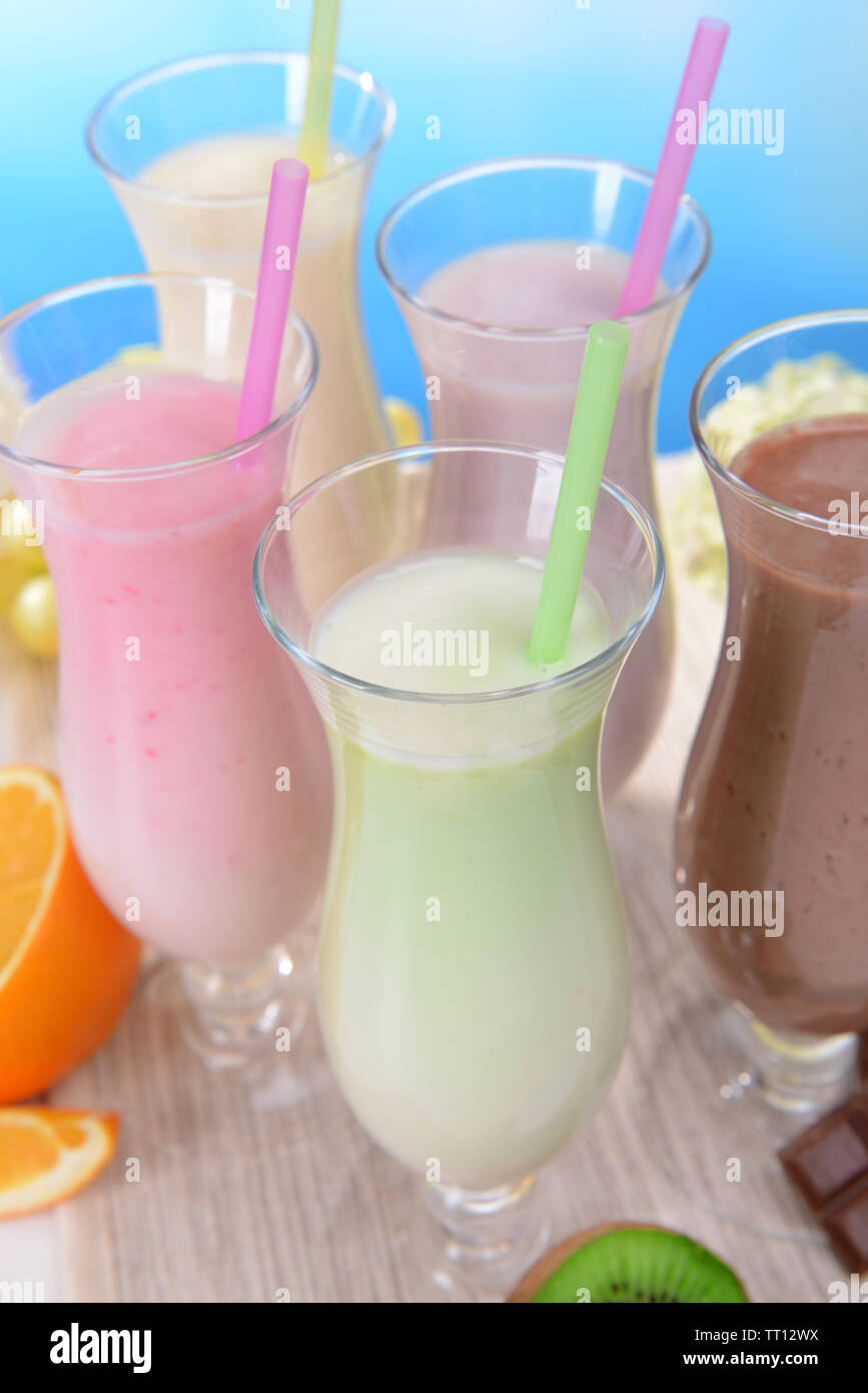 Milk shakes with fruits on table on light blue background Stock Photo ...