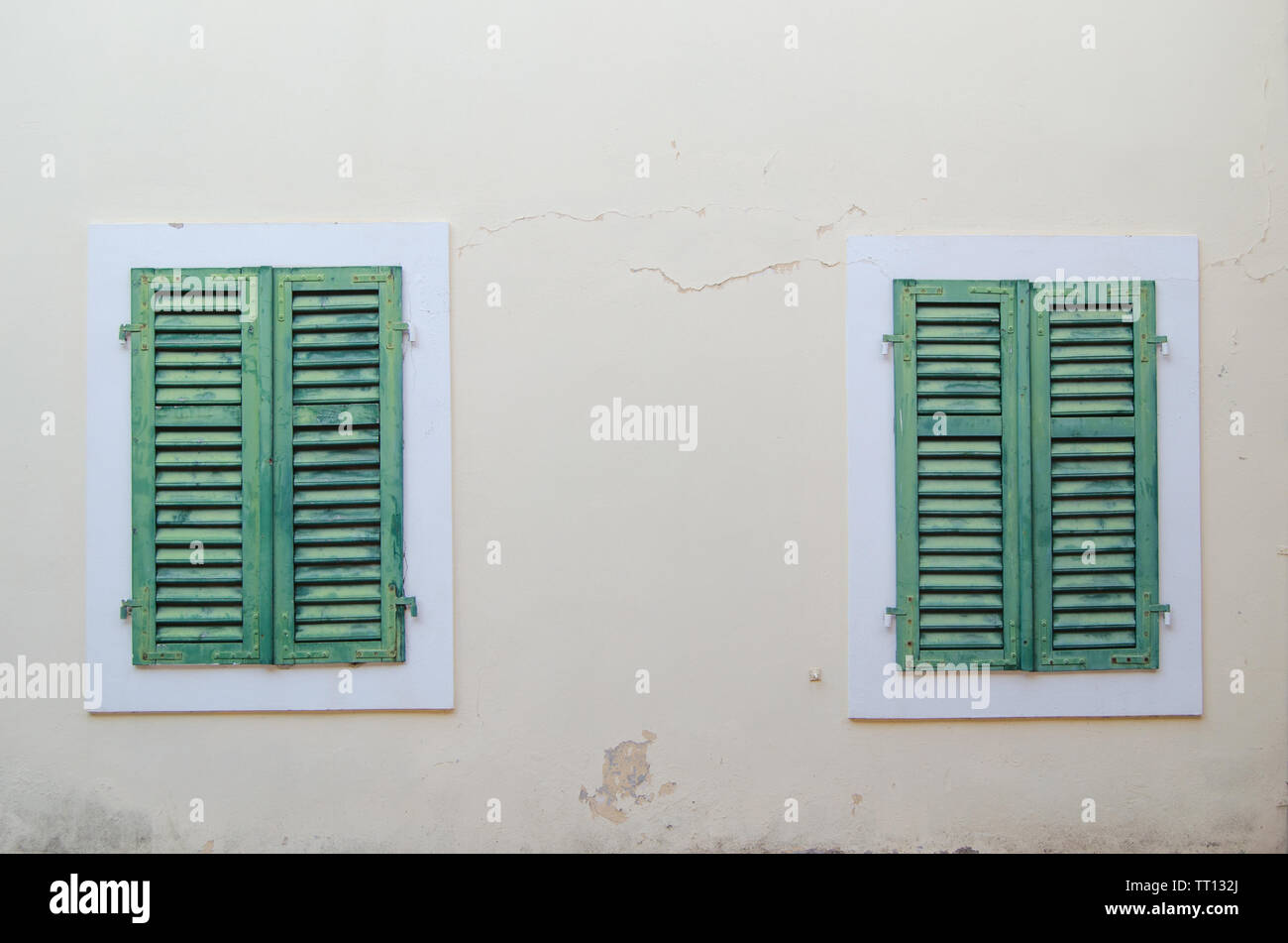 Facade of traditional frame house with two windows and shutters hi-res ...