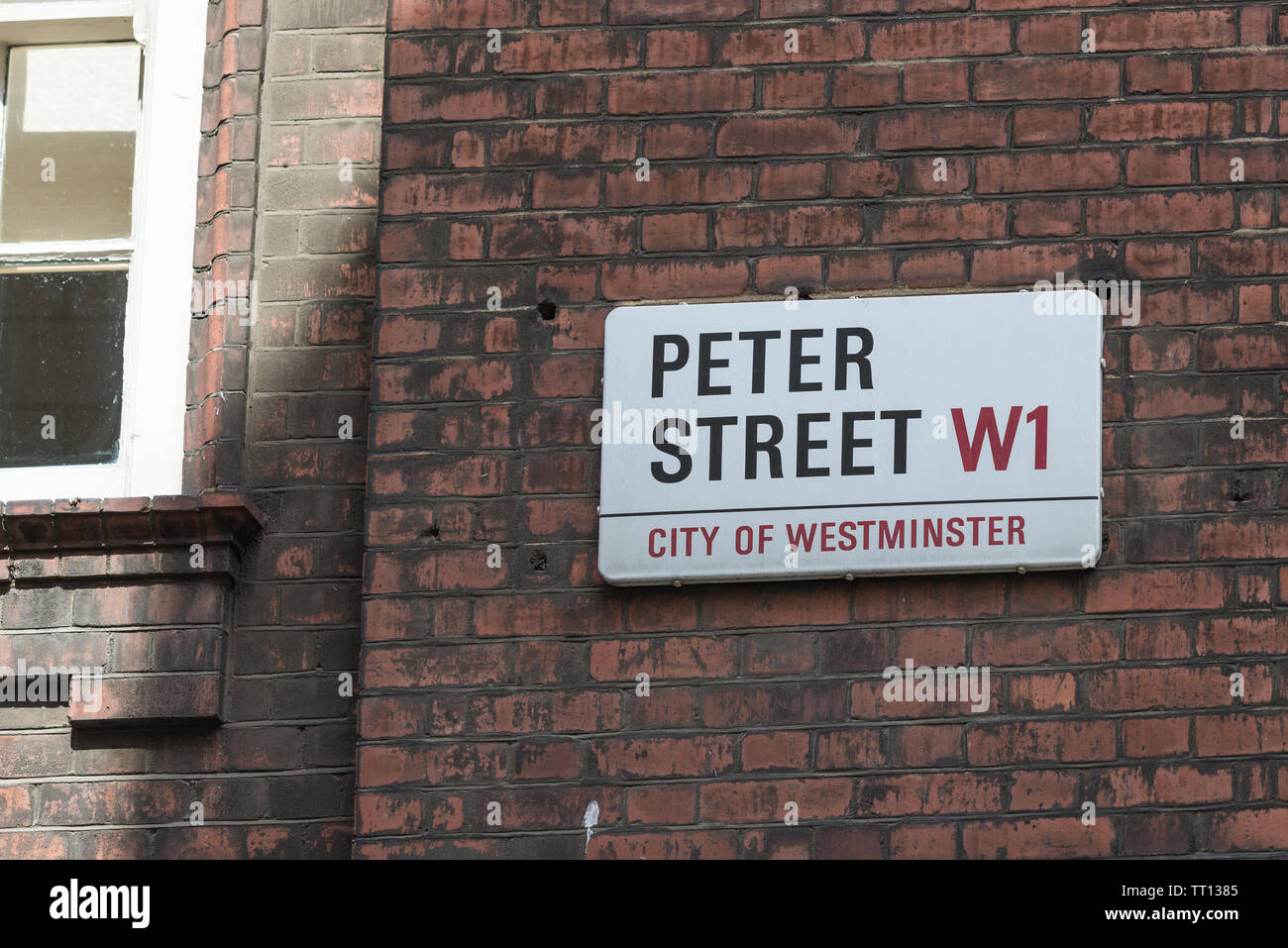 Street sign for Peter Street on wall of building, Soho, London Stock ...