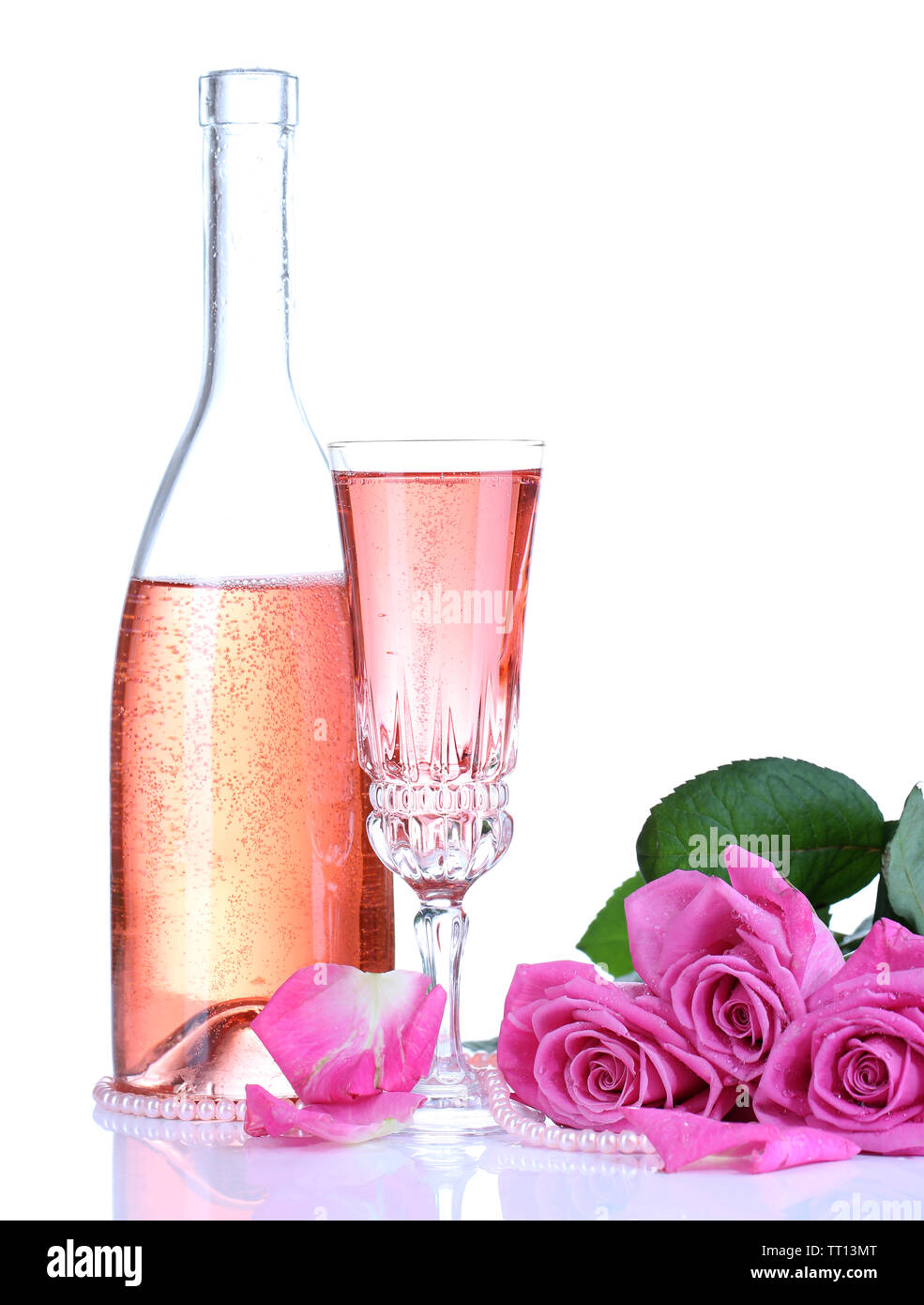 Composition with pink sparkle wine in glass, bottle and pink roses ...