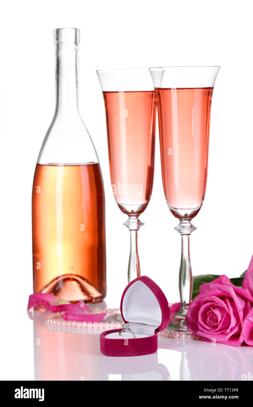 Composition with pink sparkle wine in glasses, bottle and pink roses ...