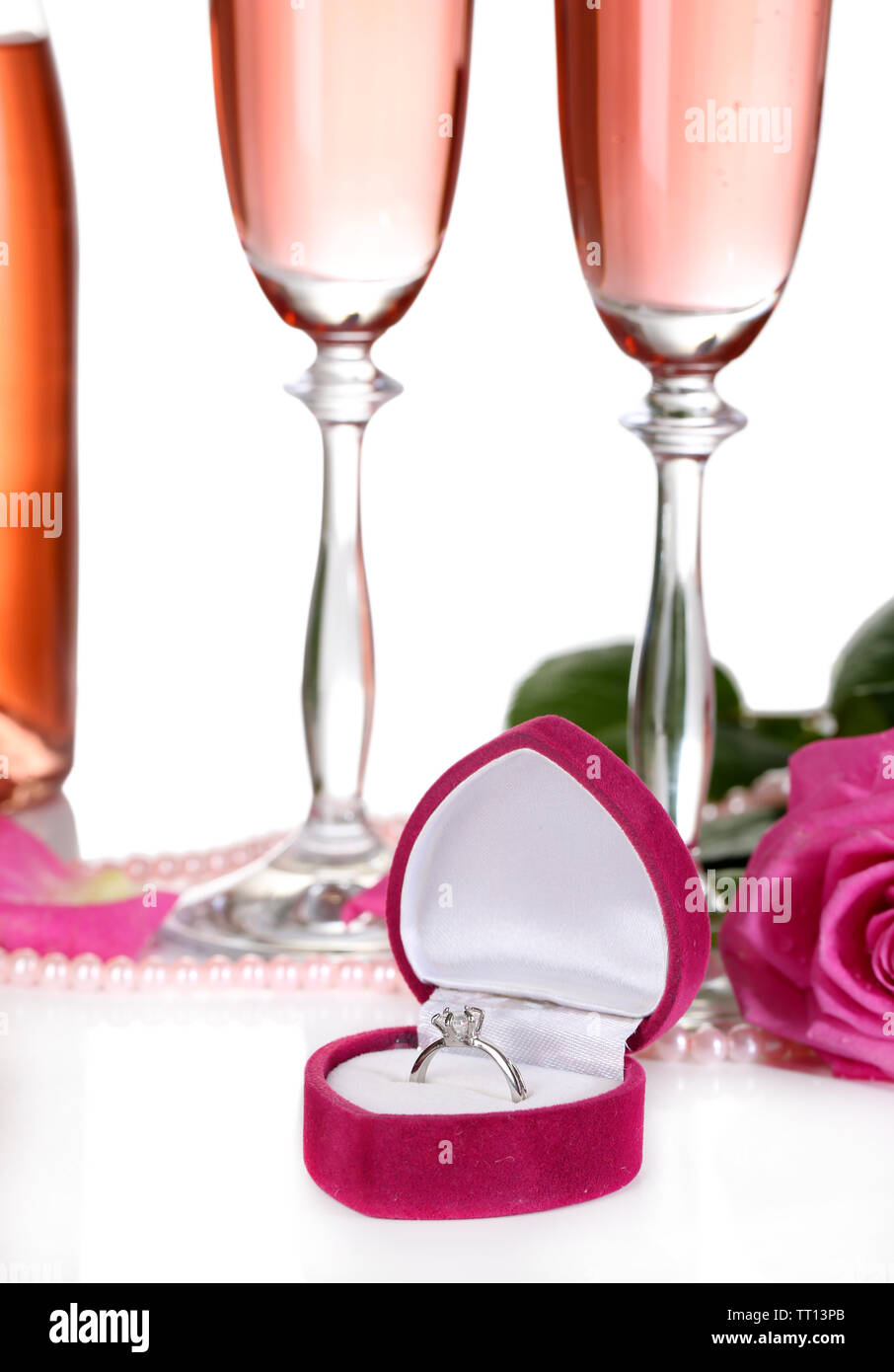 Composition with pink sparkle wine in glasses, bottle and pink roses ...