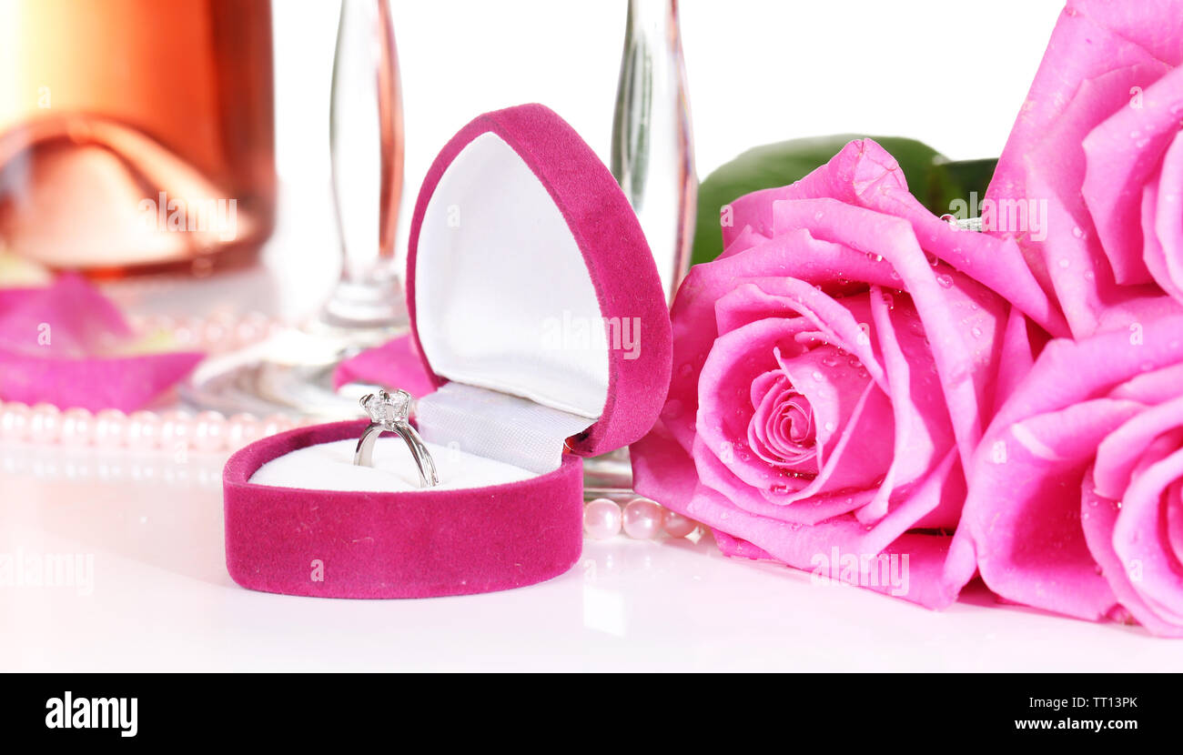 Composition with pink sparkle wine in glasses, bottle and pink roses ...
