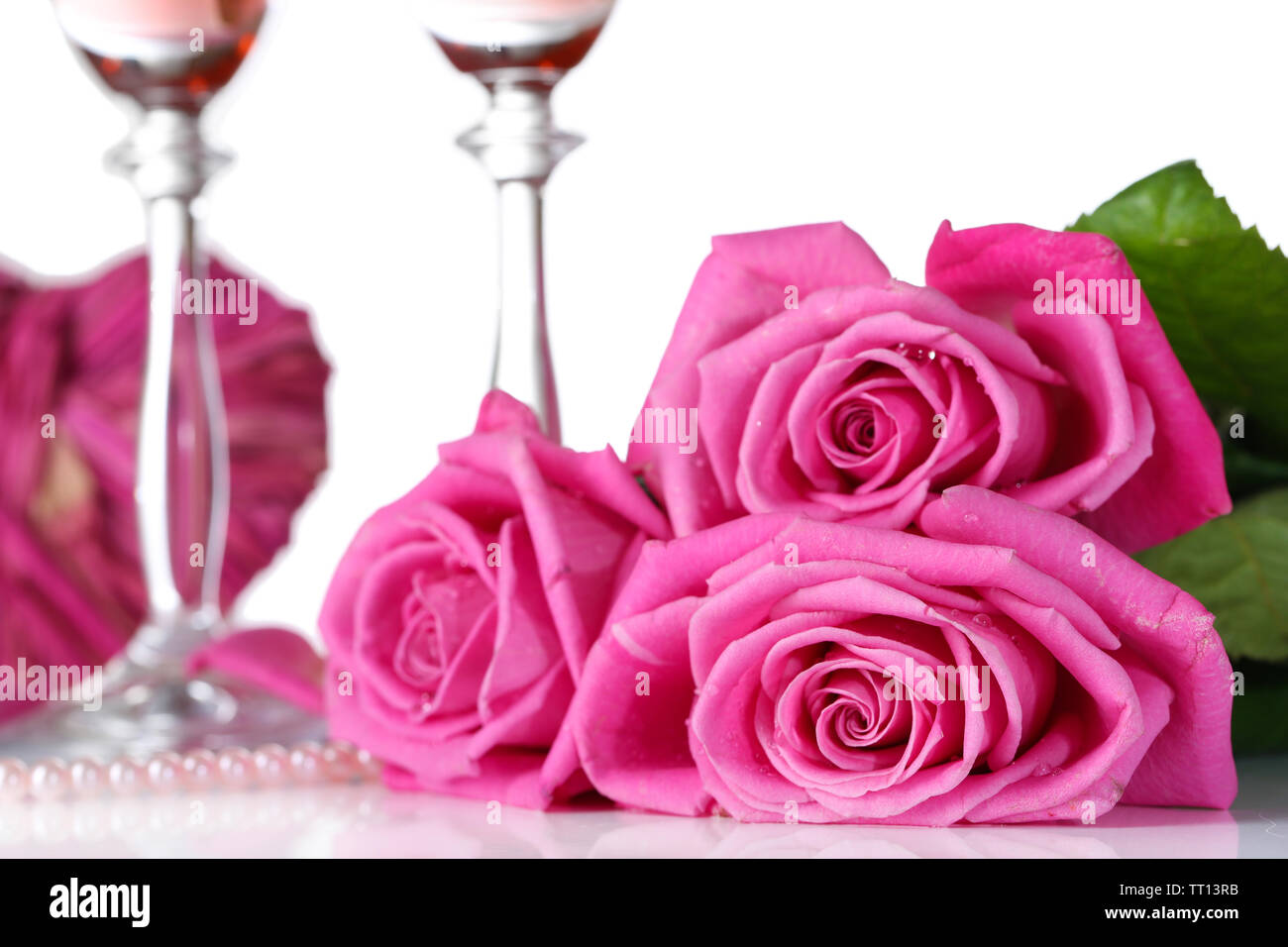 Composition with pink sparkle wine in glasses, and pink roses isolated ...
