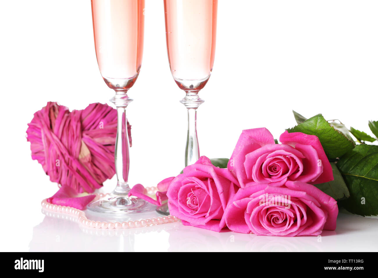 Composition with pink sparkle wine in glasses, and pink roses isolated ...