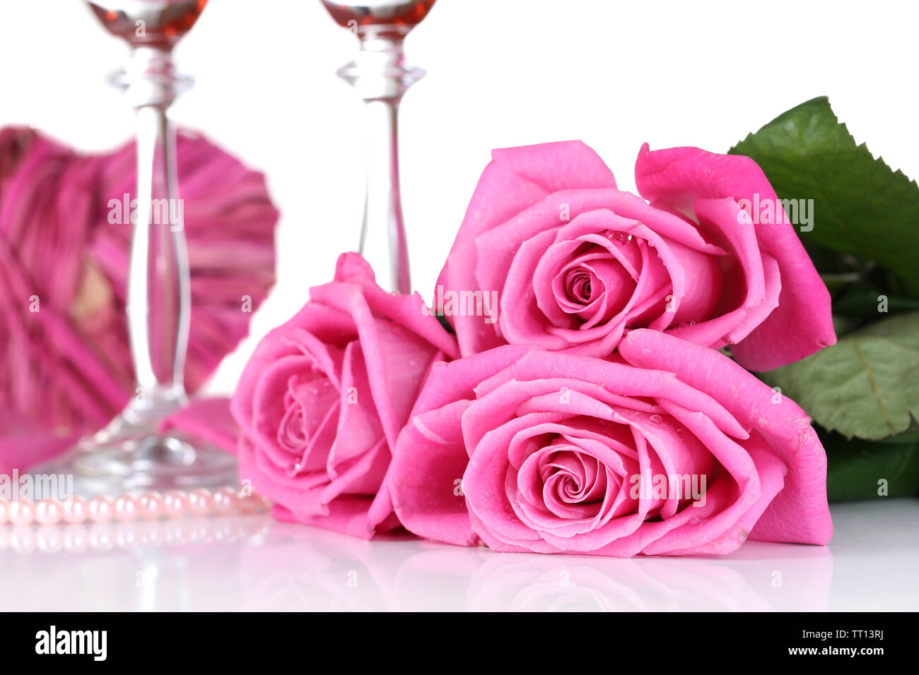 Composition with pink sparkle wine in glasses, and pink roses isolated ...