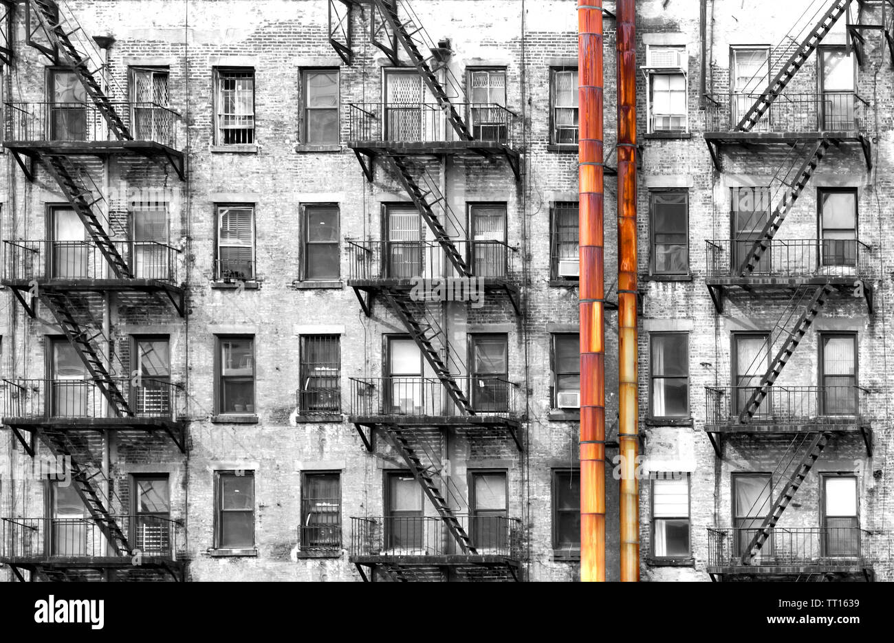 Black and white apartment building with colorful old rusted metal pipes ...