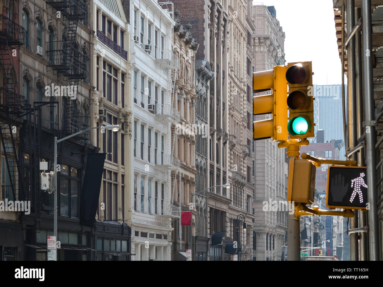Green traffic light and walk sign at an intersection in the SoHo ...