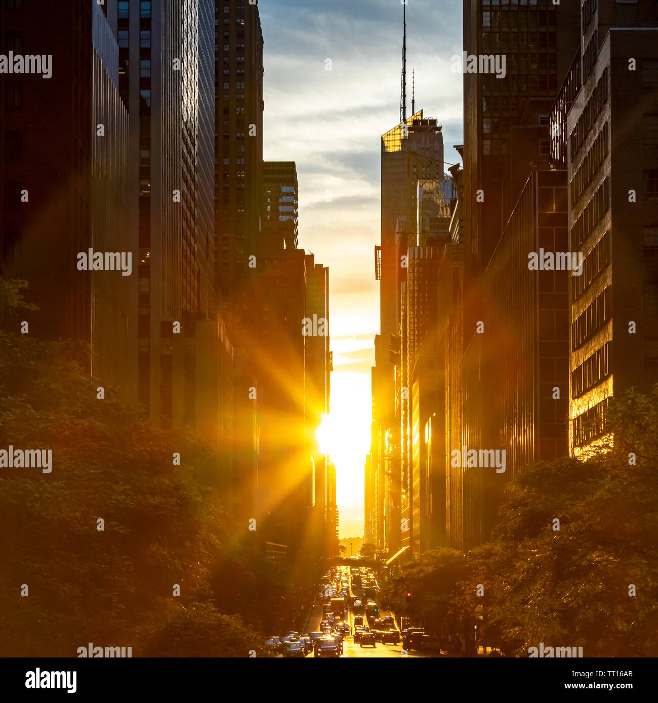 Rays of sunlight shining between the skyline buildings along 42nd ...