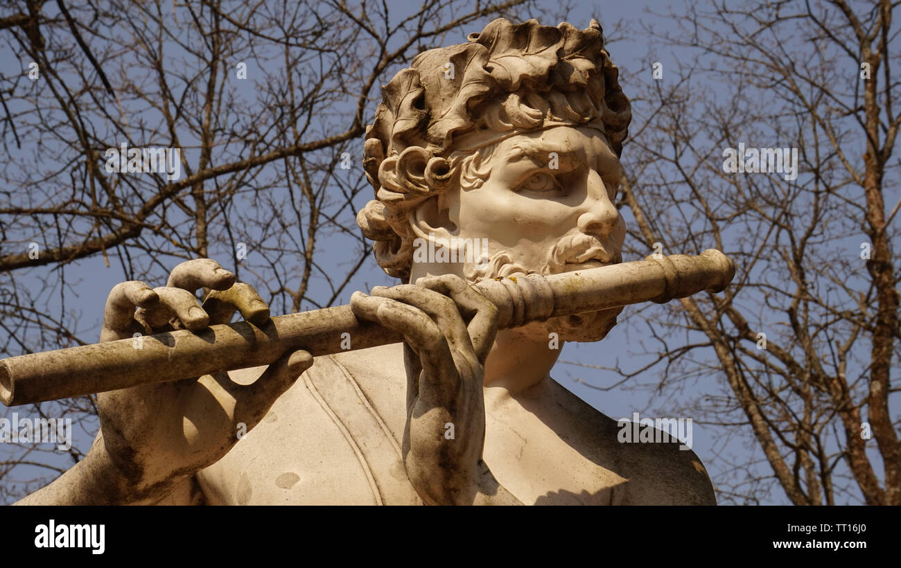Marble sculpture of a man playing flute Stock Photo - Alamy