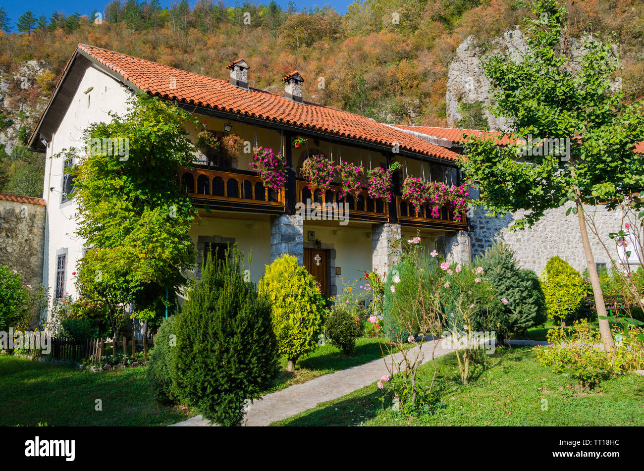 Green landscaped with flowers and trees courtyard in the old monastery ...