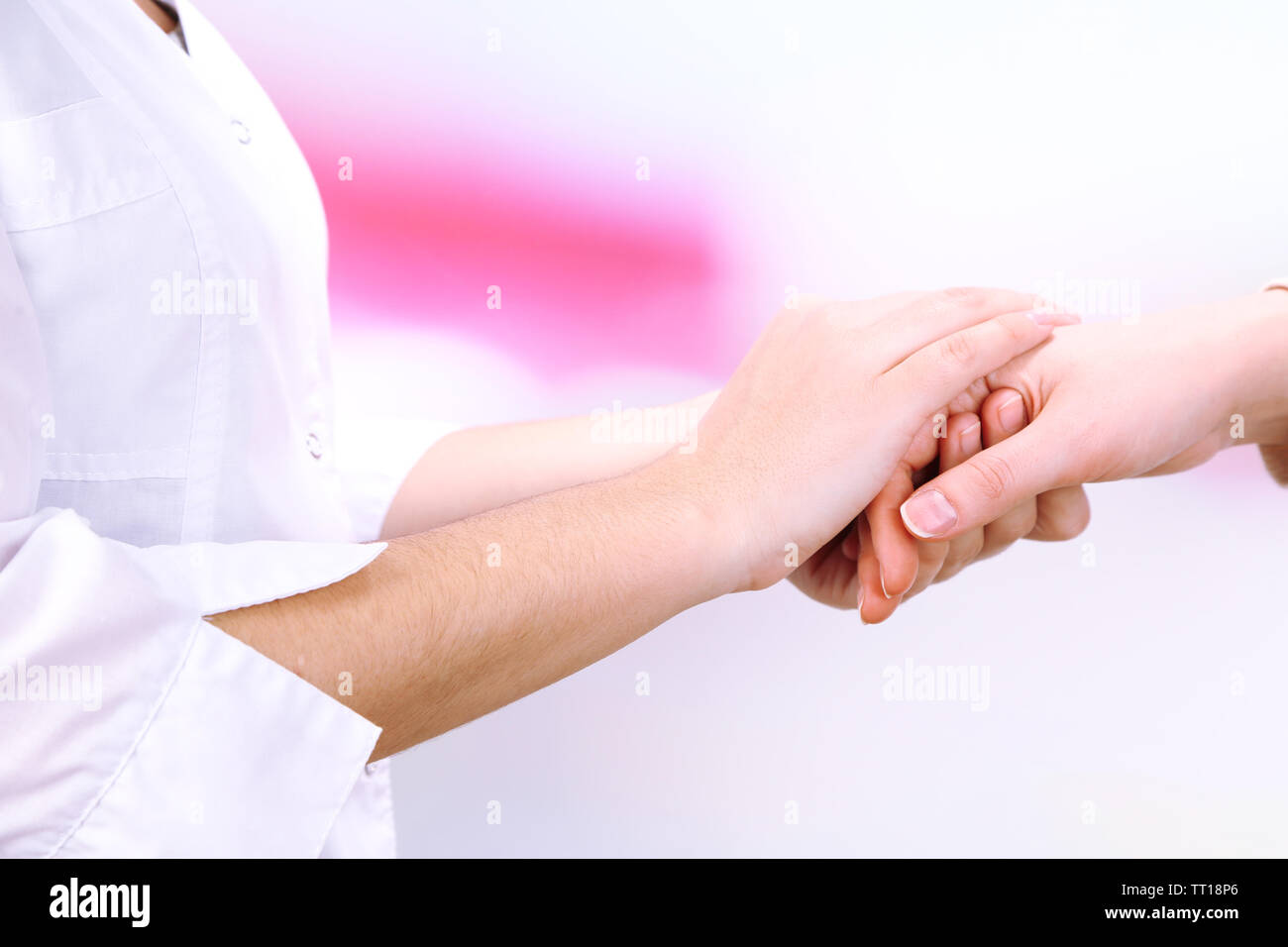 Medical doctor holding hand of patient, on light background Stock Photo ...