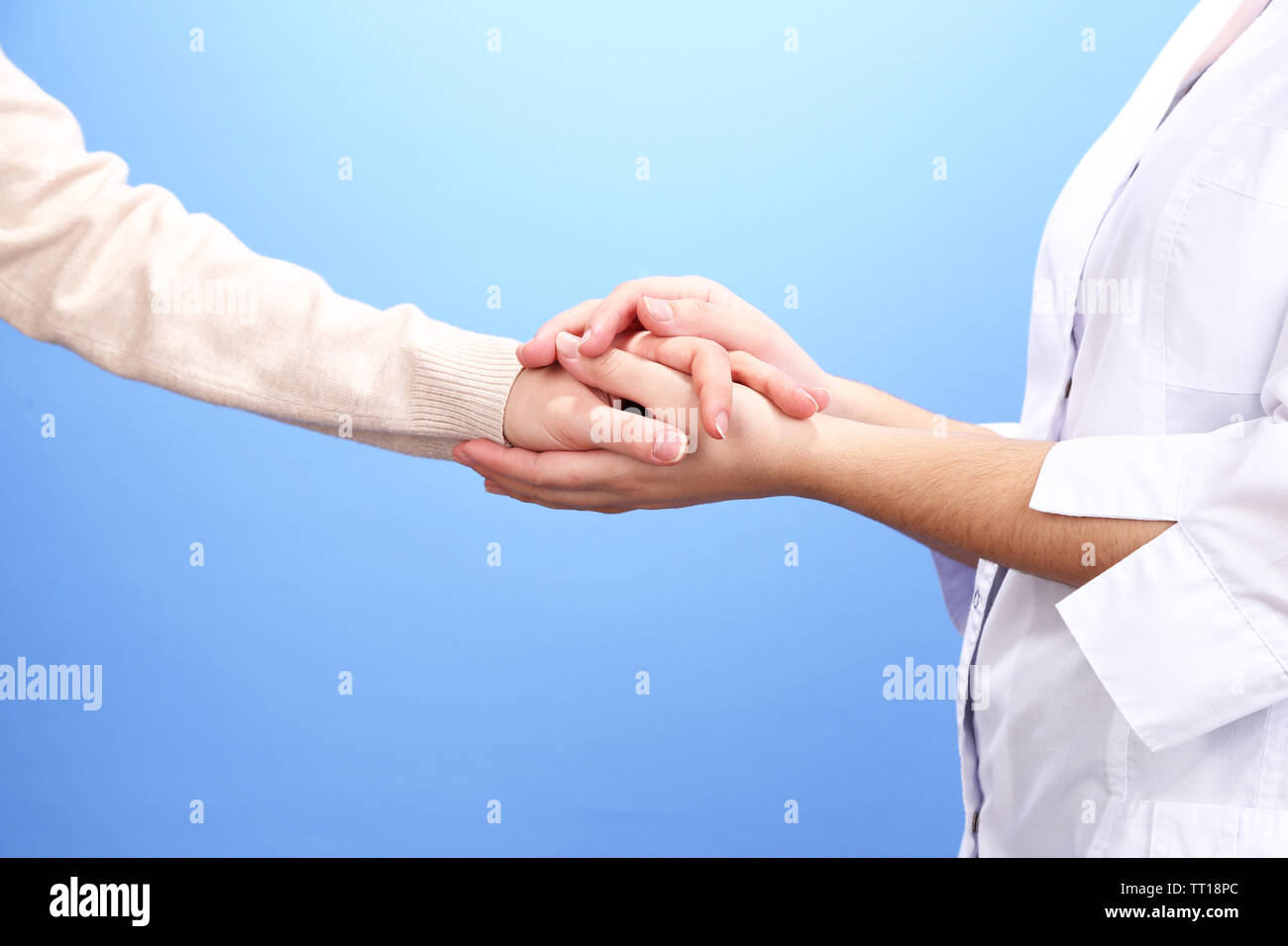 Medical doctor holding hand of patient, on light background Stock Photo ...
