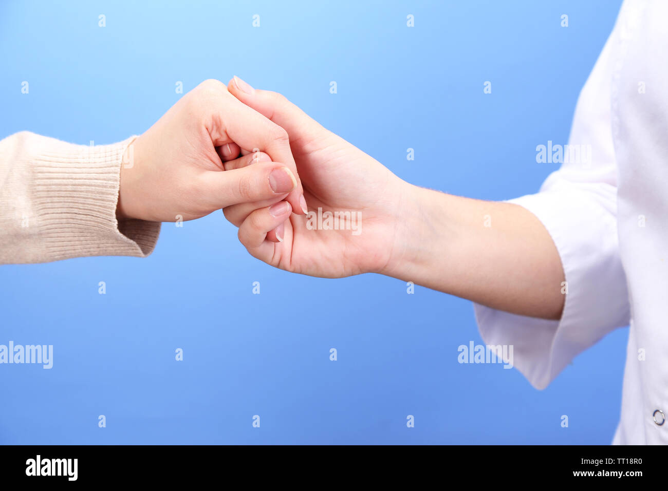 Medical doctor holding hand of patient, on light background Stock Photo ...