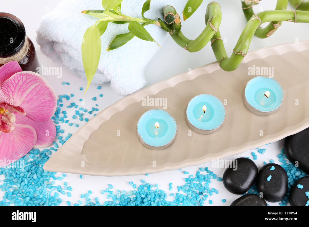Beautiful spa setting with flower isolated on white Stock Photo - Alamy