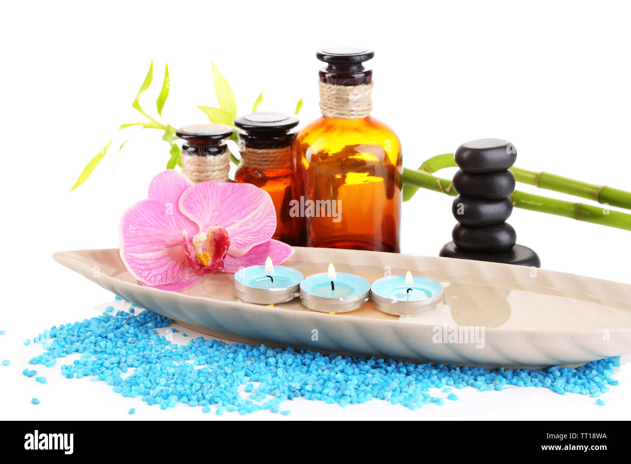 Beautiful spa setting with flower isolated on white Stock Photo - Alamy