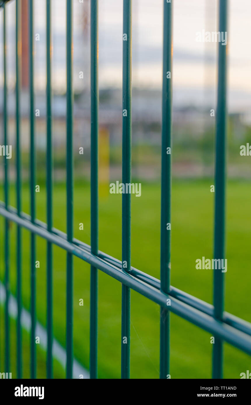 Fencing football field of metal mesh Stock Photo - Alamy