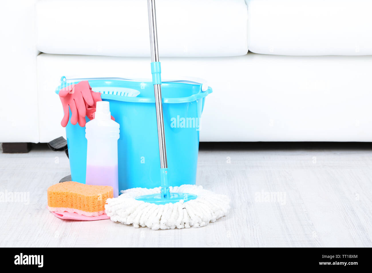 Floor mop and bucket for washing in room Stock Photo - Alamy
