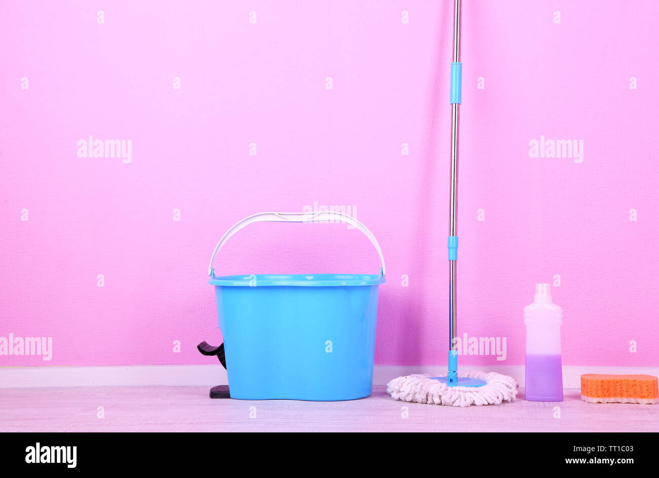 Floor mop and bucket for washing in room on pink wall background Stock ...