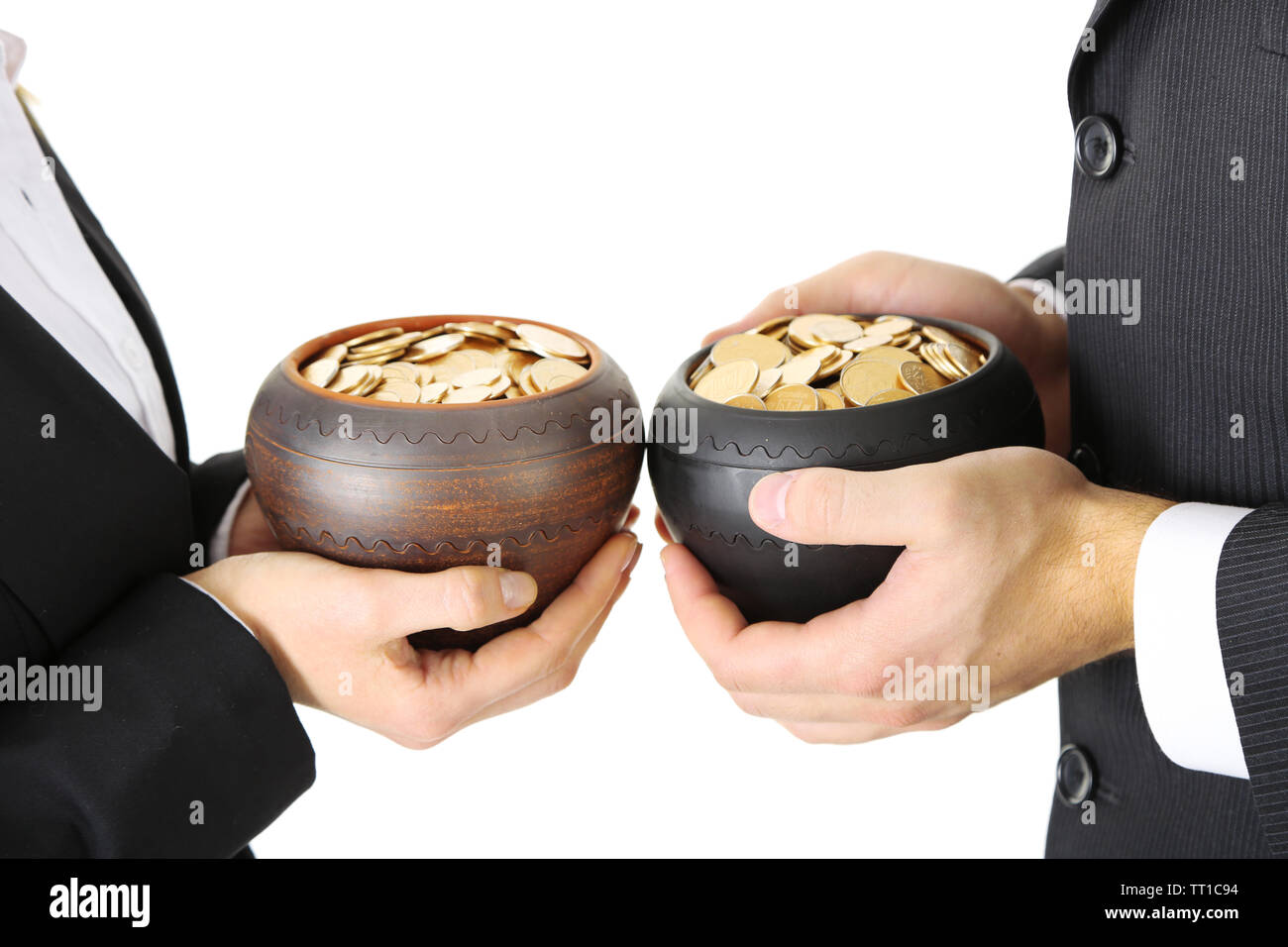 Two ceramic pots with golden coins in male and female hands, isolated ...