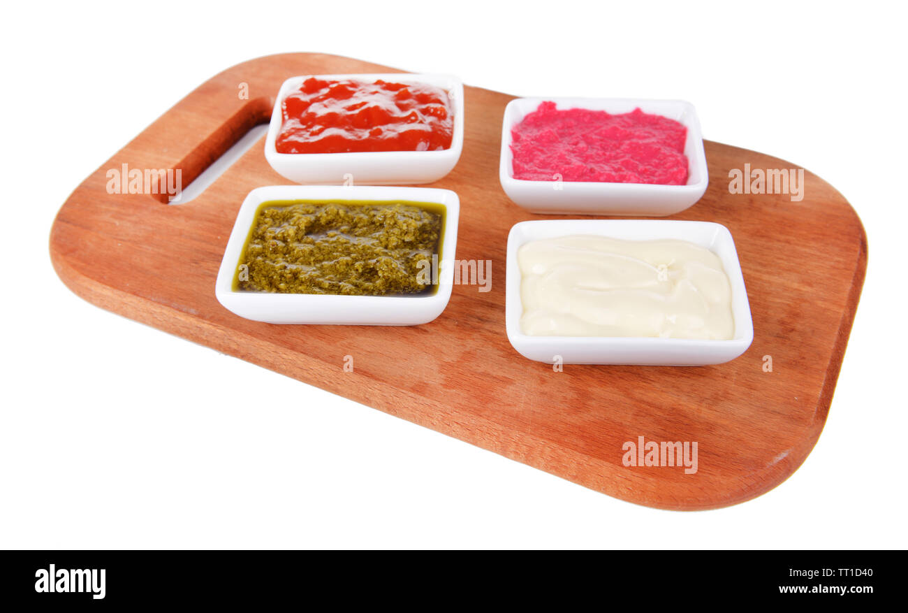 Various sauces on chopping board isolated on white Stock Photo - Alamy