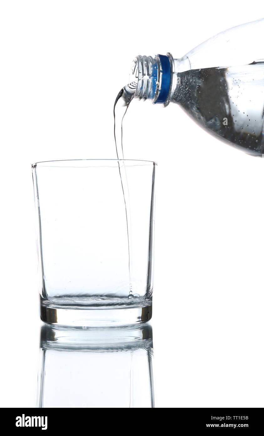 Pour water from bottle into glass, on light blue background Stock Photo ...