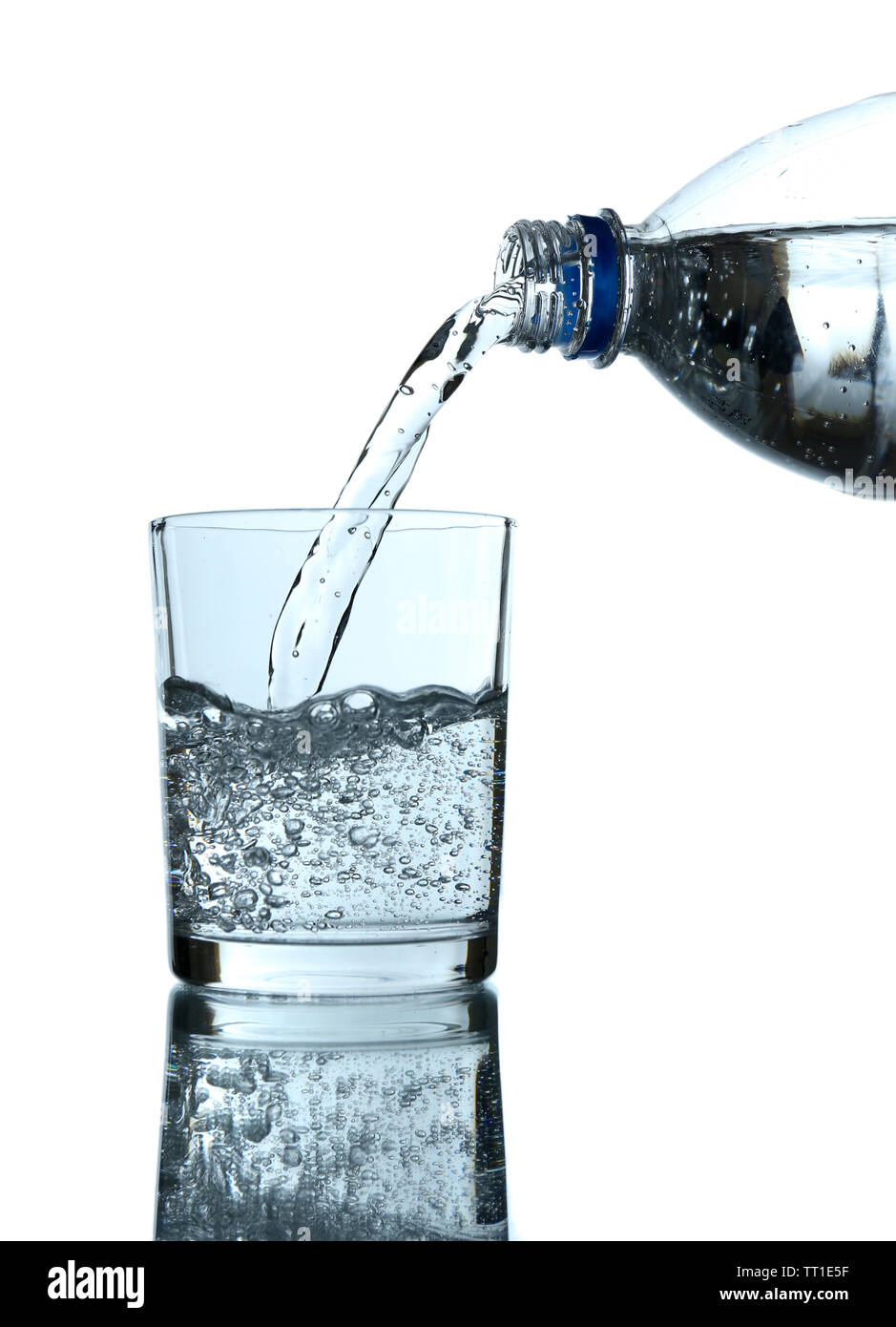 Pour water from bottle into glass, on light blue background Stock Photo ...