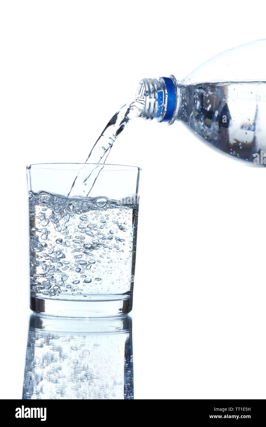 Pour water from bottle into glass, on light blue background Stock Photo ...