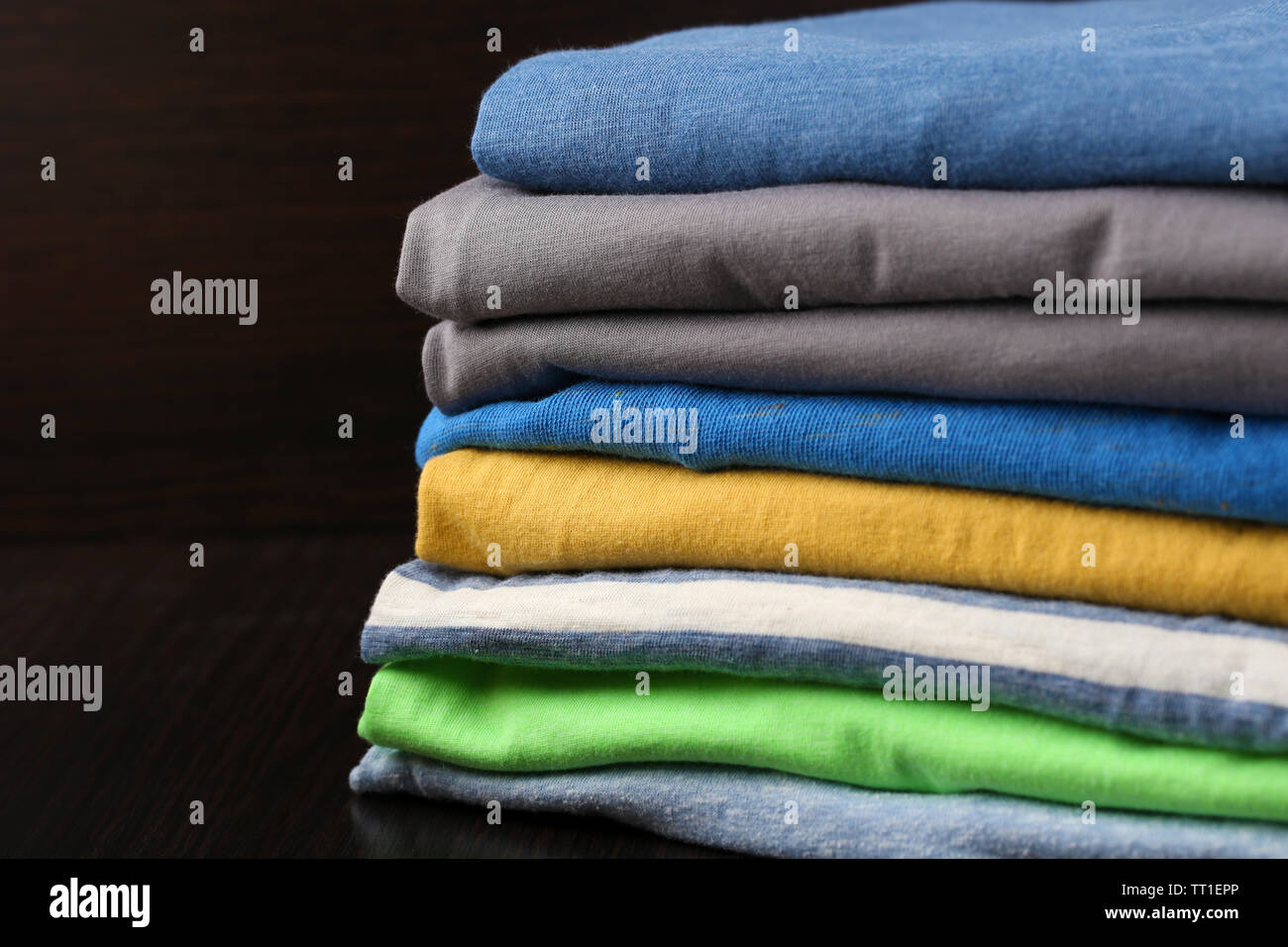 Stack of colorful clothes, isolated on black Stock Photo - Alamy
