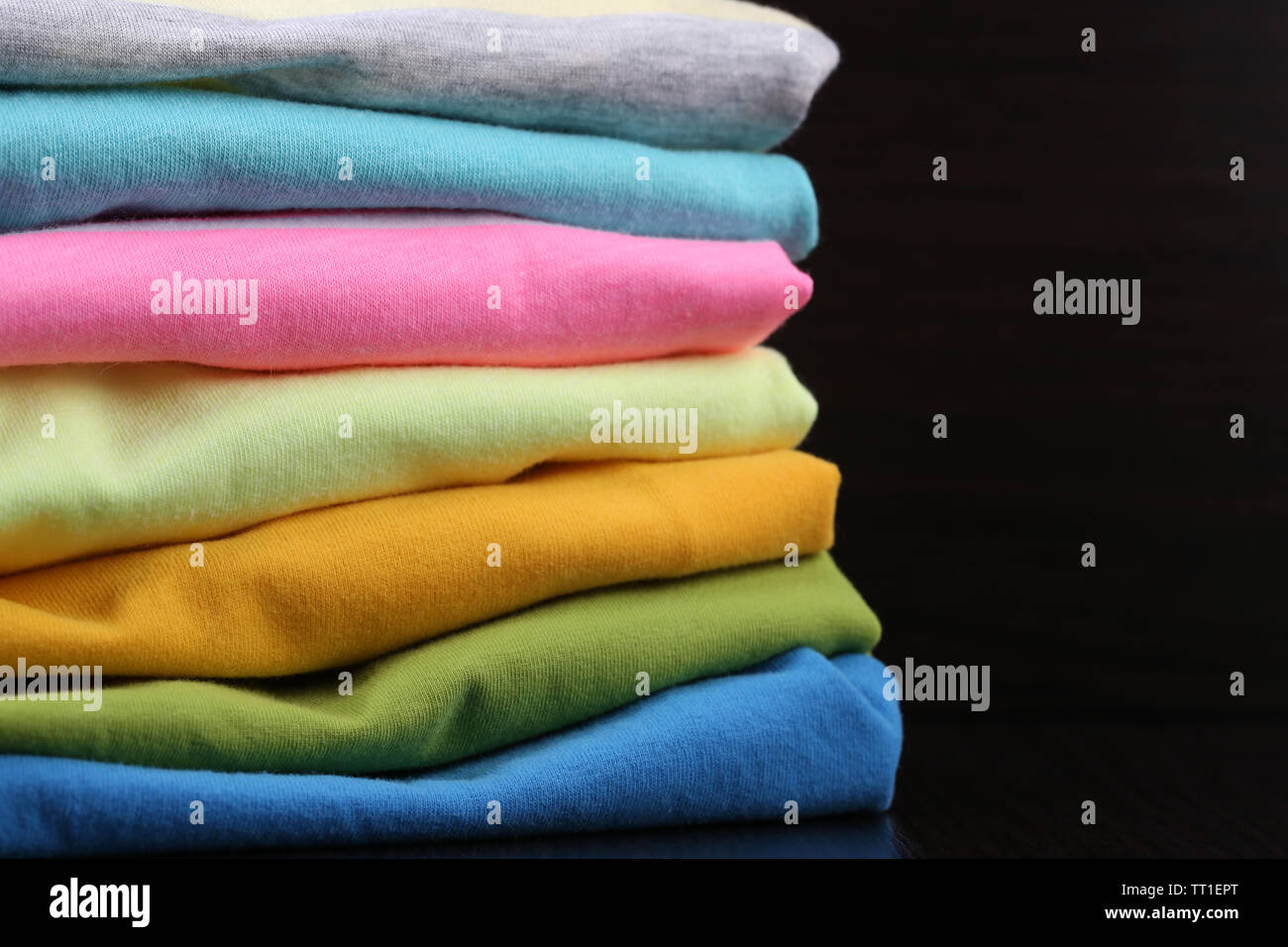 Stack of colorful clothes, isolated on black Stock Photo - Alamy
