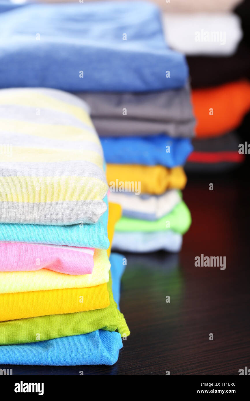 Stack of colorful clothes, on dark background Stock Photo - Alamy