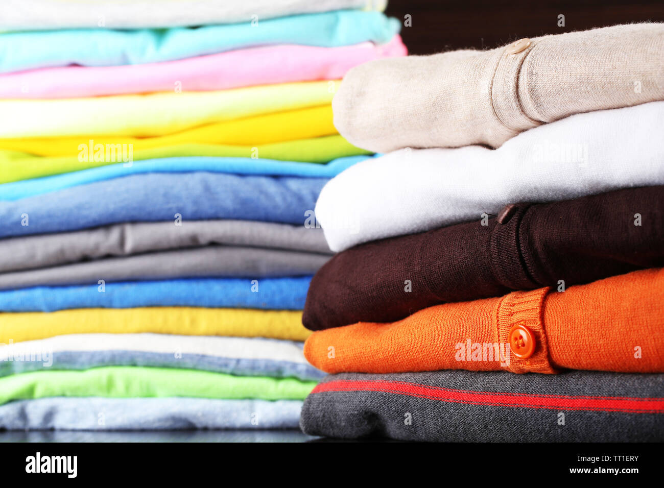 Stack of colorful clothes, on dark background Stock Photo - Alamy