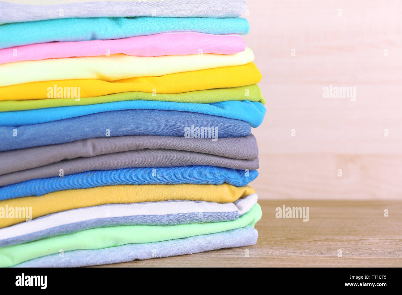 Stack of colorful clothes, on light background Stock Photo - Alamy
