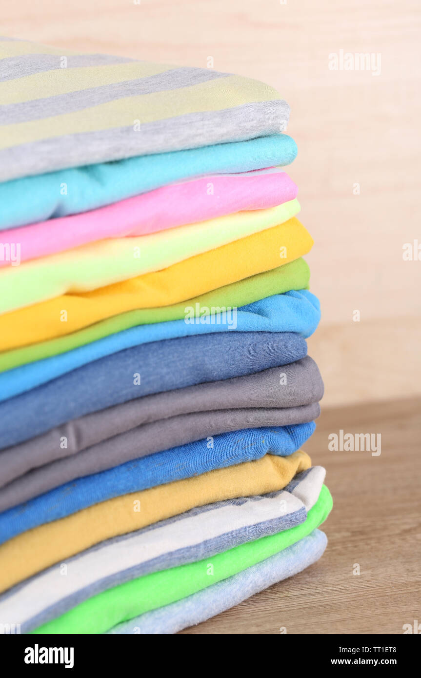 Stack of colorful clothes, on light background Stock Photo - Alamy