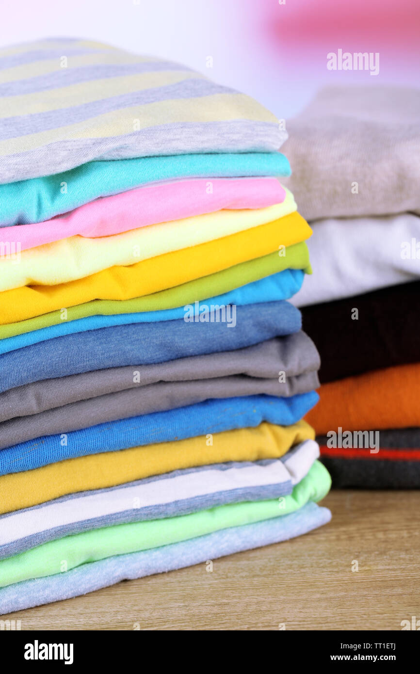 Stack of colorful clothes, on light background Stock Photo - Alamy
