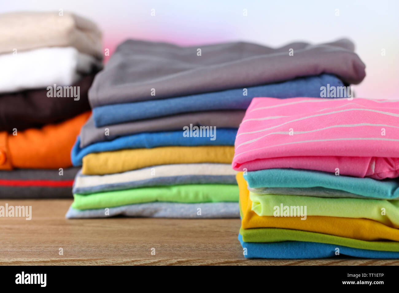 Stack of colorful clothes, on light background Stock Photo - Alamy