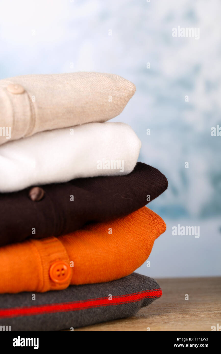 Stack of colorful clothes, on light background Stock Photo - Alamy