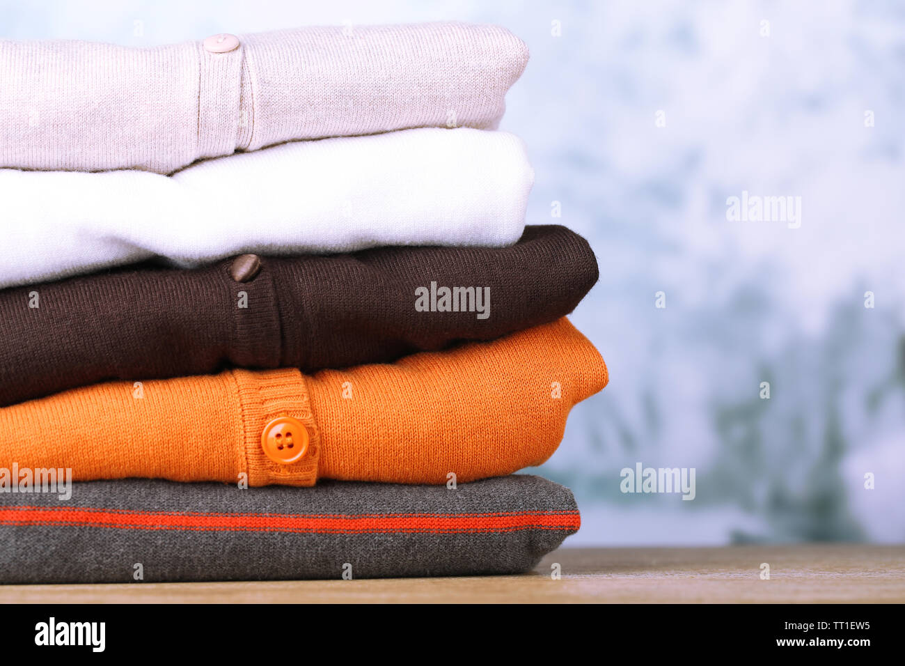 Stack of colorful clothes, on light background Stock Photo - Alamy