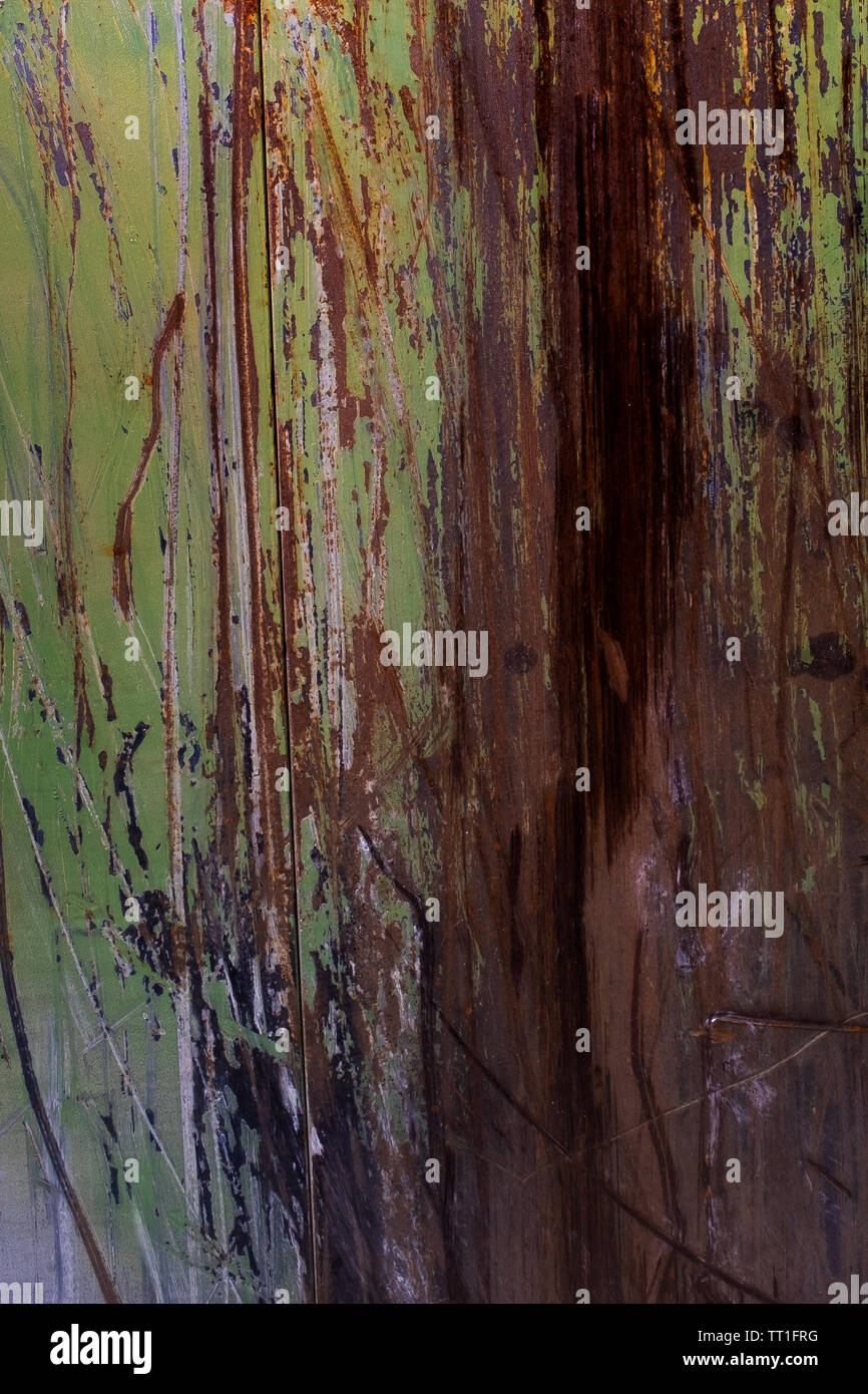 Metal surface with long vertical scratches and small crack, extensive ...